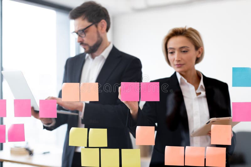 Business Professionals Collaborating with Sticky Notes on Transparent ...
