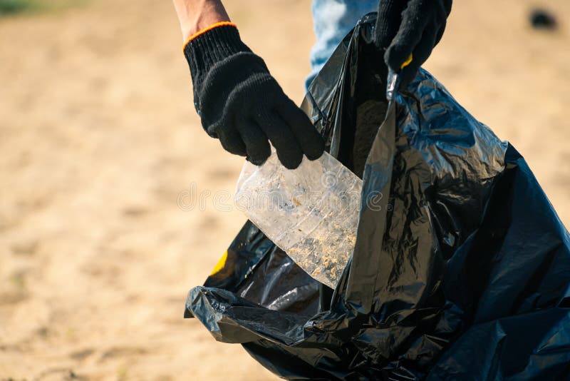 Volunteer Sit and Picking Up Garbage on the Beach Stock Photo - Image ...
