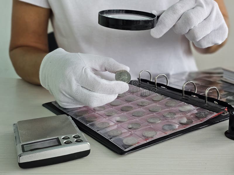 Collecting and Evaluating Coins with a Magnifying Glass and Scale in a ...