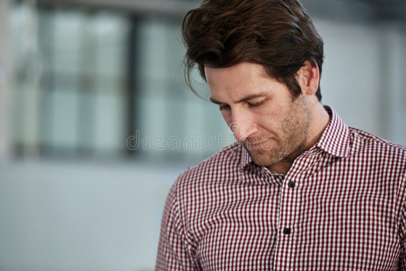 Collecting His Thoughts A Handsome Man Standing In An Office Stock
