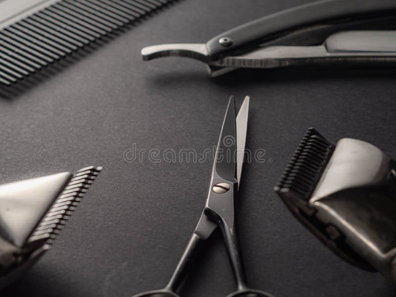 A Collection of Barbering Tools is Displayed on a Dark Surface ...