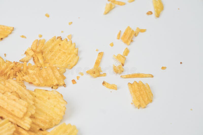 A Collection of Broken, Fried Potato Chips on a Speckled Gray Surface ...