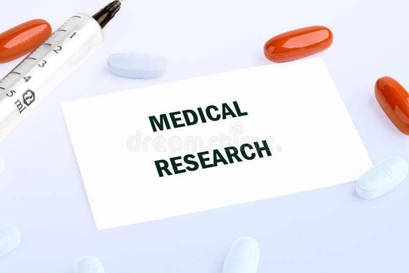 A Collection of Capsules and Tablets are Spread Around a Card that ...