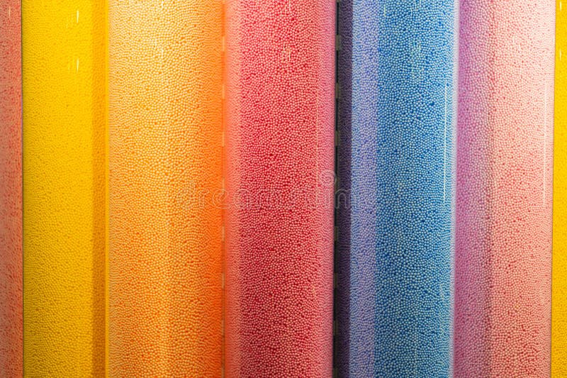 A Collection of Colorful Tubes are Arranged Side by Side in a Container ...