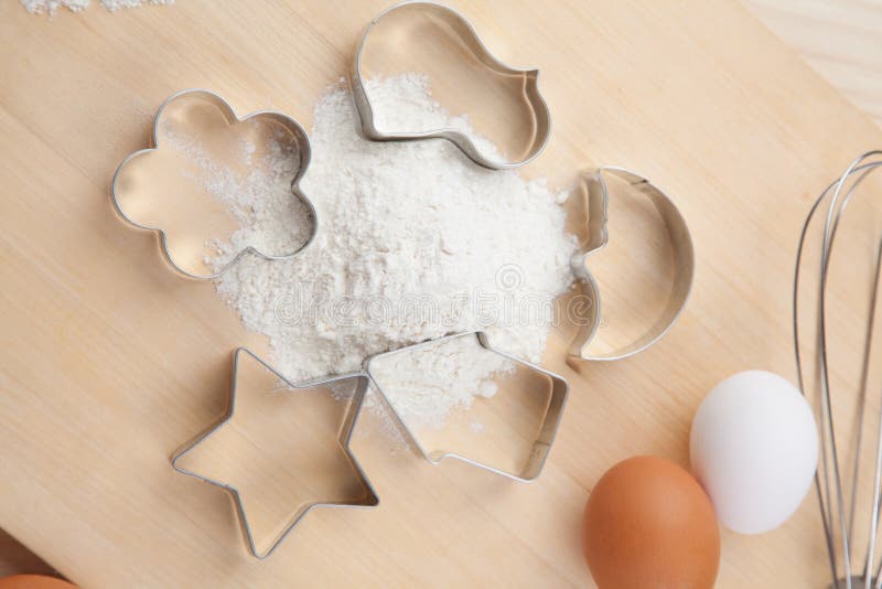 Collection of Cookie Cutter Forms Around Flour on Wooden Board Stock ...