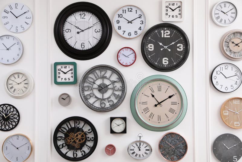 Collection of Different Clocks Hanging on White Wall Stock Photo ...