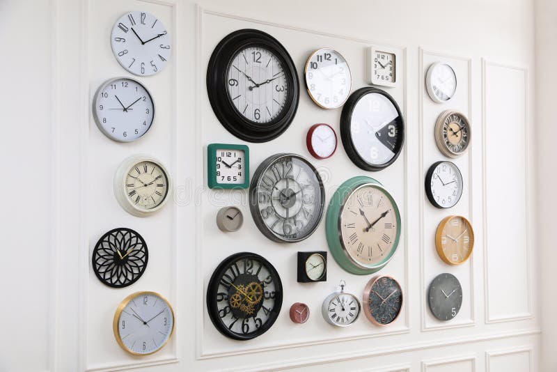 Collection of Different Clocks Hanging on White Wall Stock Image ...