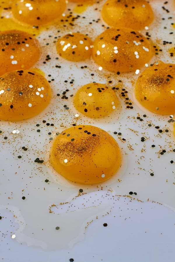 Collection of Egg Yolks Covered with Decorative Sparkles. Stock Photo ...