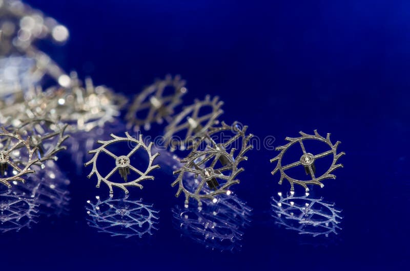 Collection of Escape Wheels Resting in a Blue Surface Stock Photo ...