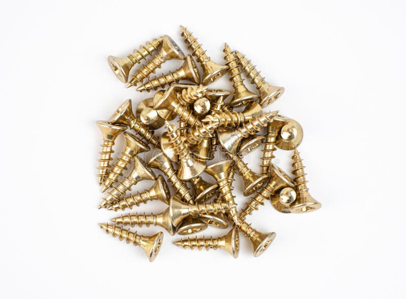 A Collection of Gold Colored Screws Placed Closely Together on a Plain ...