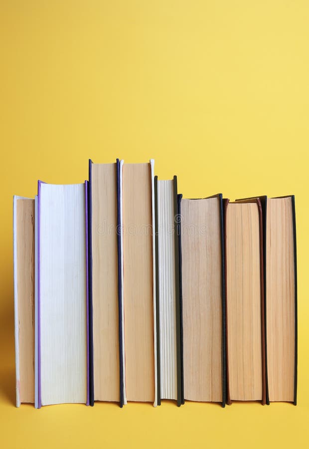 Collection of Hardcover Books on Yellow Background Stock Image - Image ...