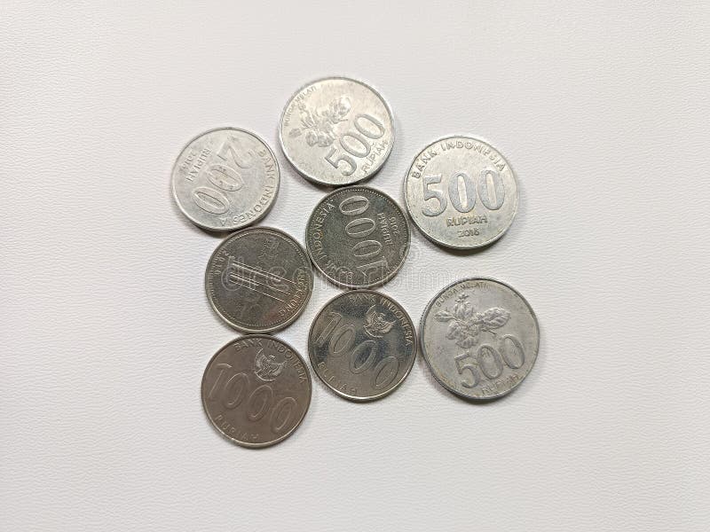 A Collection of Indonesian Rupiah Coins Placed on a White Surface ...