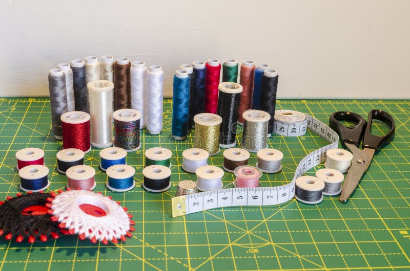 Collection of Items Used in a Sewing Kit on a Cutting Mat with White ...