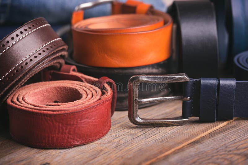 Leather Colored Belts on a Wooden Table Stock Image - Image of business ...