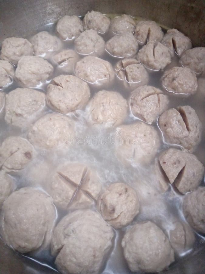 A Collection of Meatballs that are Split and Seized in a Container ...