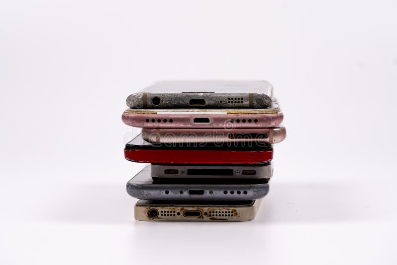 Collection of Old Mobile Phones Stacked in Disarray on a Clean Surface ...