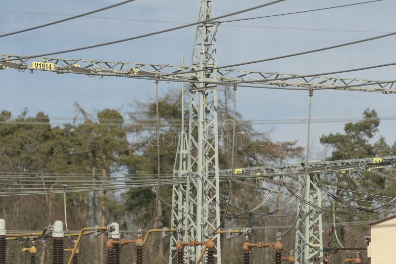A Collection of Power Lines is Suspended from a Tall Tower Structure ...