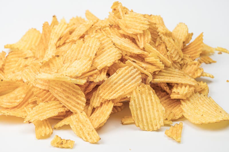 Collection of Ridged Yellow Potato Chips on a White Surface in Even ...