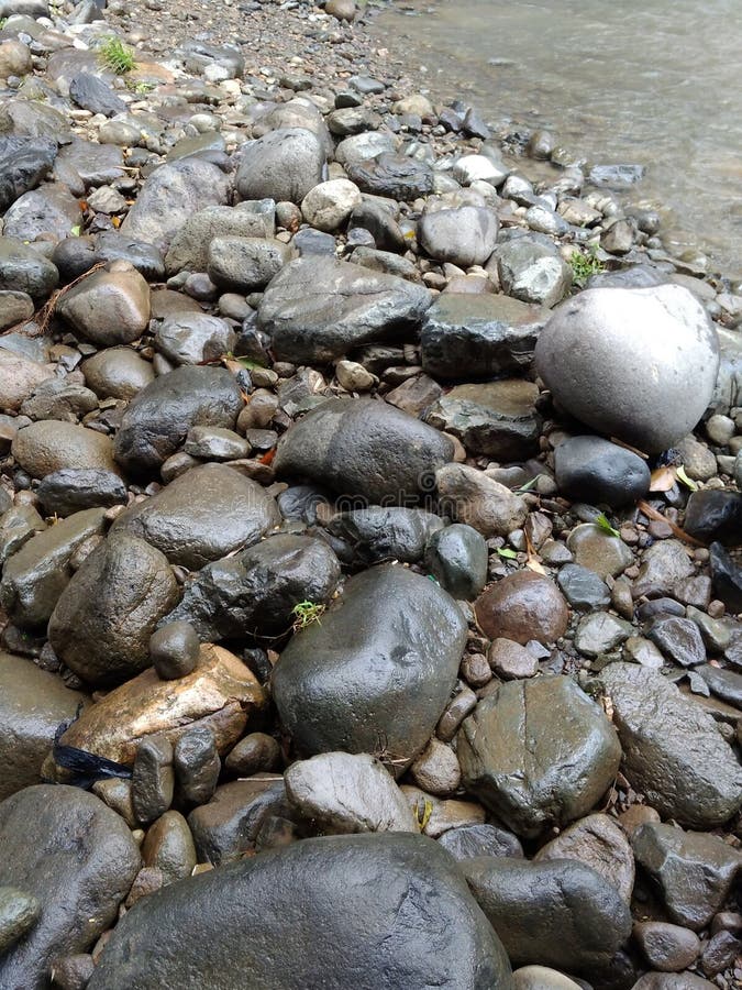 A Collection of Rocks on the Edge of the River Looks Natural Stock ...