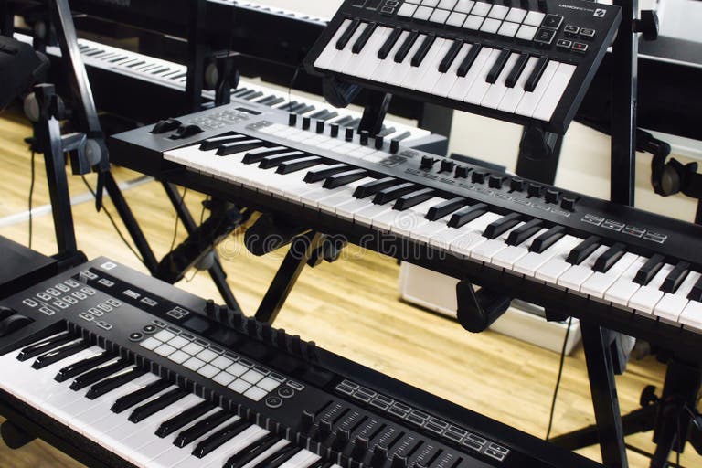 A Collection of Several Digital MIDI Keyboards with Knobs and Faders ...