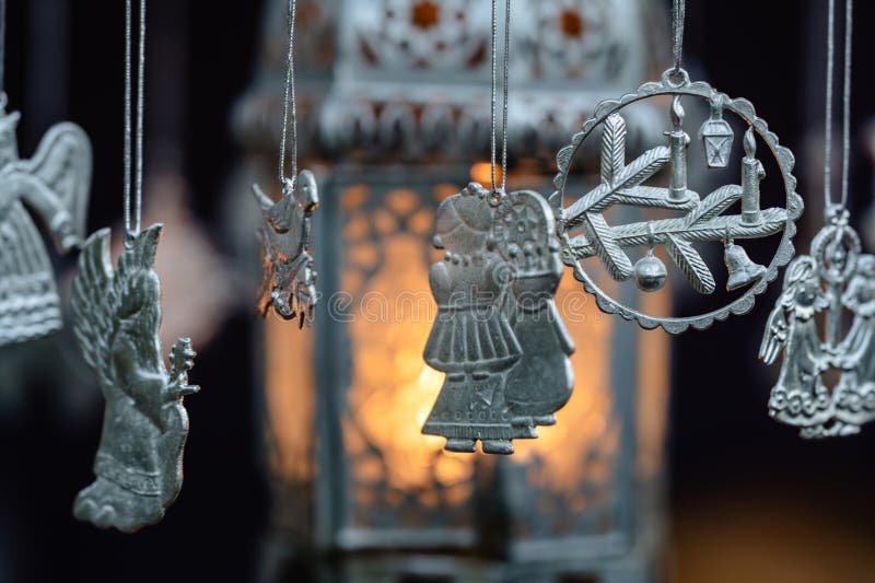 A Collection of Silver Ornaments Hanging from a Lamp, Including Angels ...