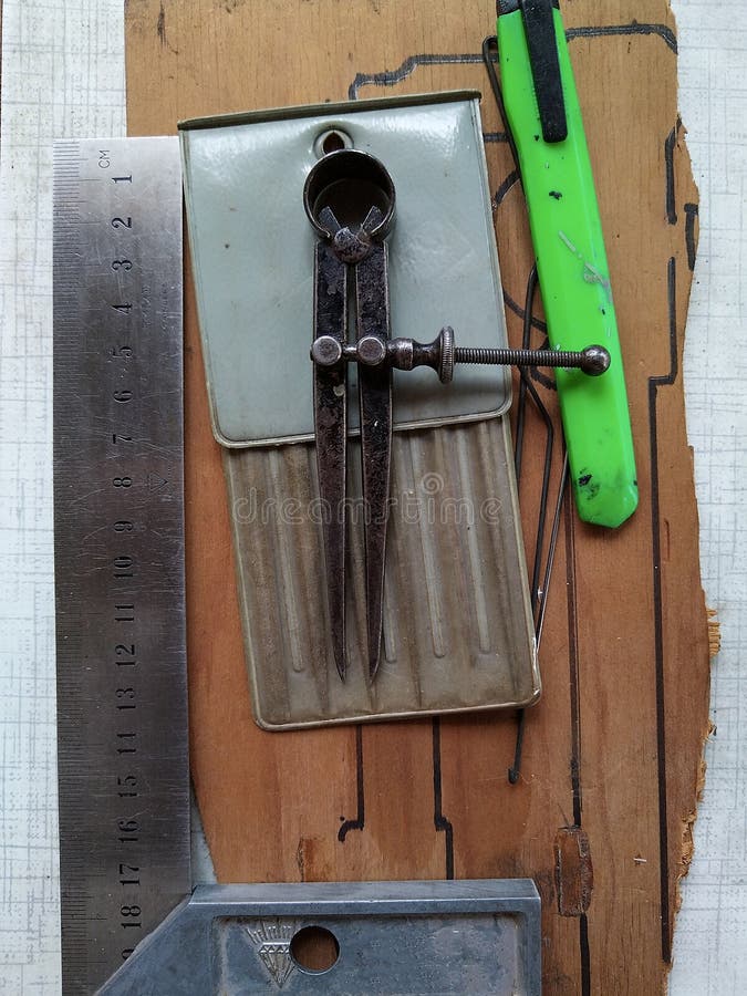 Collection of Tools on a Wooden Surface with Drawn Outlines Stock Photo ...