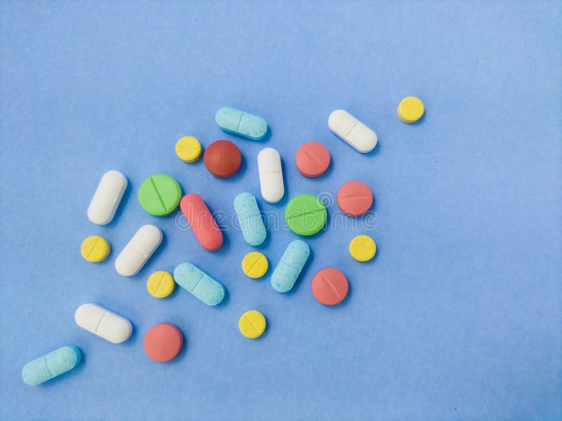 Various Tablets in Different Shapes, Sizes, and Colors on a Blue ...