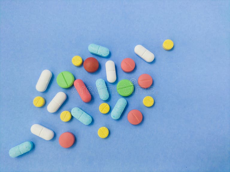 Various Tablets in Different Shapes, Sizes, and Colors on a Blue ...