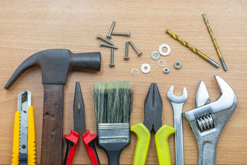 Collection of Various Used Hand Tools Organized on a Wooden Surface for ...