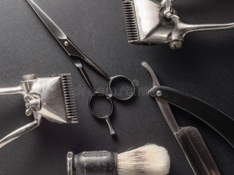 A Collection of Vintage Barber Tools Arranged on a Black Surface. the ...