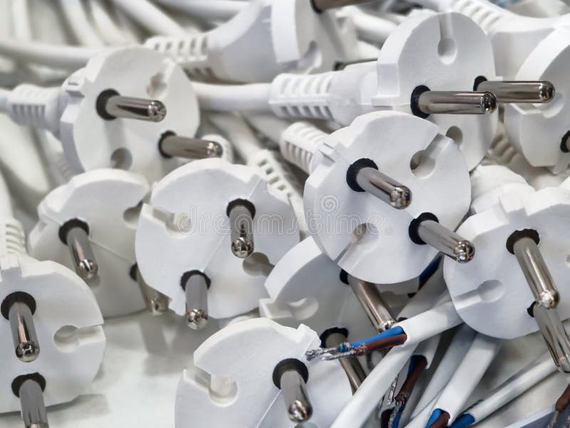 Collection of White Electrical Plugs Piled Together on a Flat Surface ...