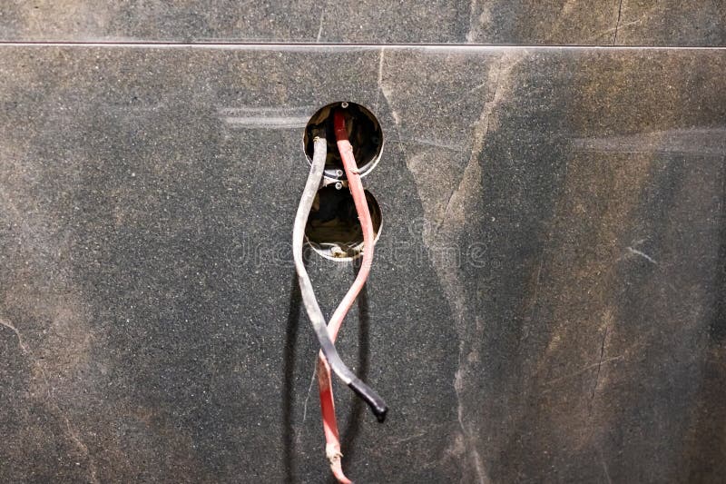 A Collection of Wires is Dangling from an Opening in a Wall Stock Photo ...