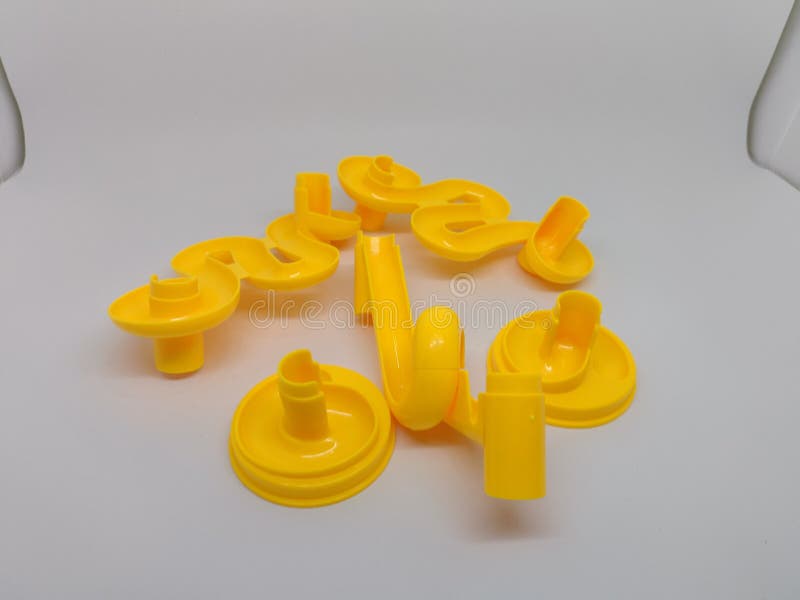 Collection of Yellow Plastic Marble Run Track Components on White ...