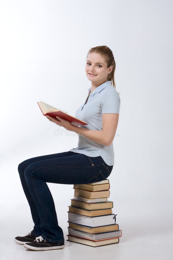 College Female Student Sitting on Stack Books Stock Image - Image of ...