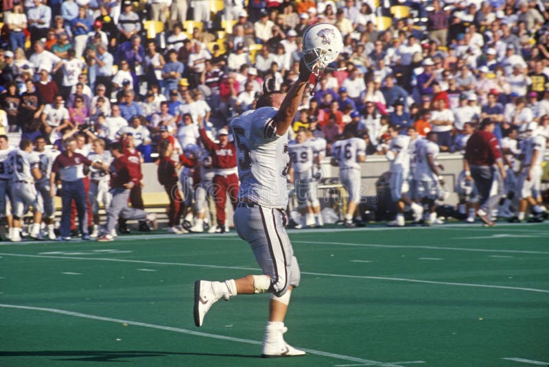 College Football Players Running at Halftime Editorial Photo - Image of ...