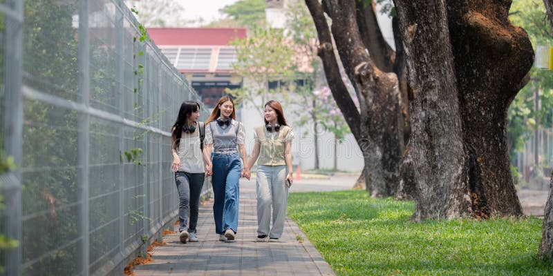 College Friends Walk To Class Together. University Student in Campus ... College Friends Walk To Class Together. University Student in Campus ...