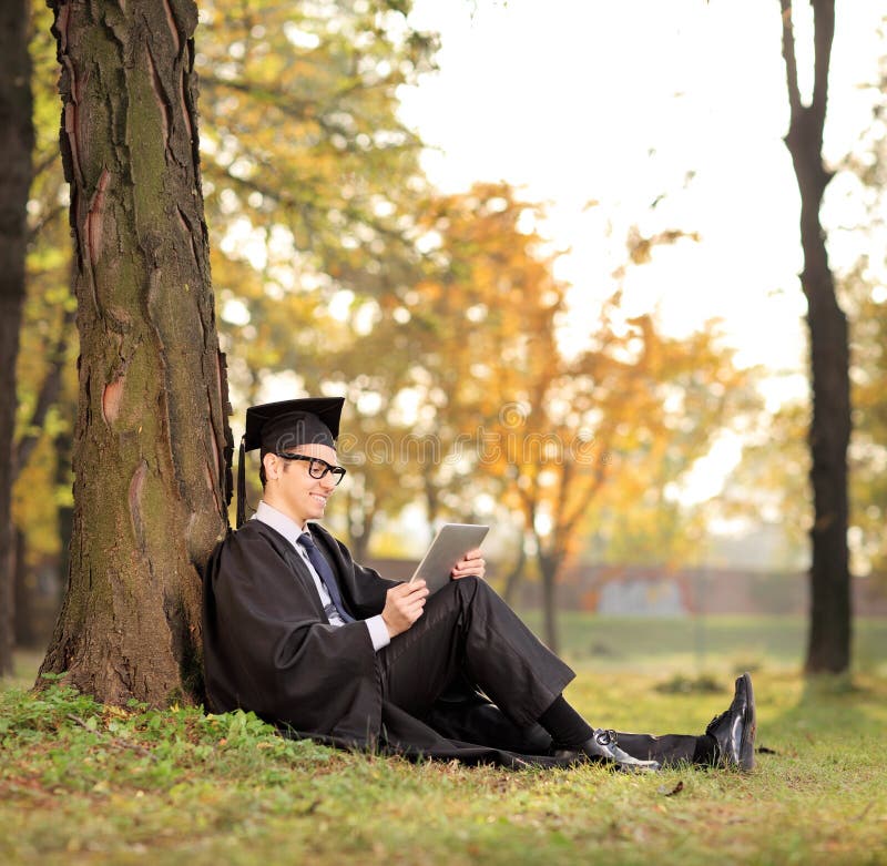 College Graduate Working on a Tablet in Park Stock Photo - Image of ...