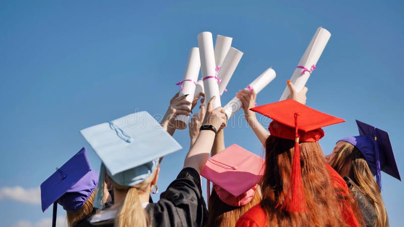 College Graduates with Caps Tie Their Diplomas Together. Stock Image ...