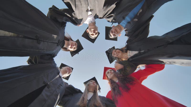College Graduates in a Circle Stand Hugging Each Other. Stock Video ...