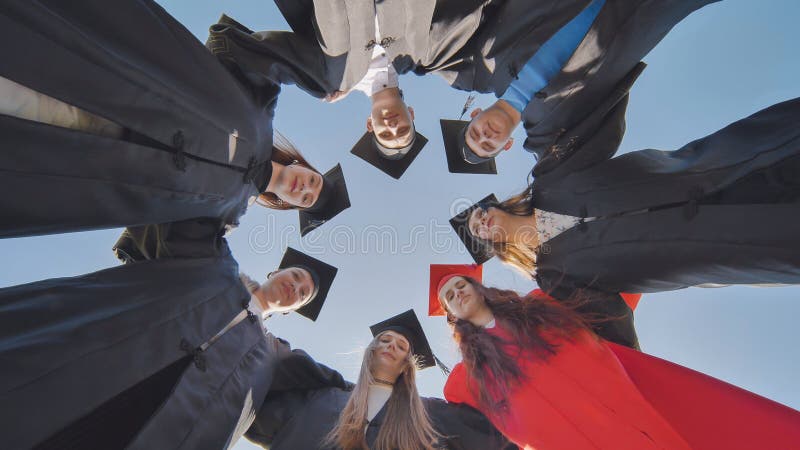 College Graduates in a Circle Stand Hugging Each Other. Stock Image ...