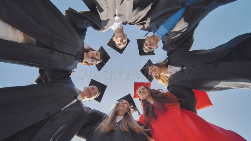 College Graduates in a Circle Stand Hugging Each Other. Stock Photo ...