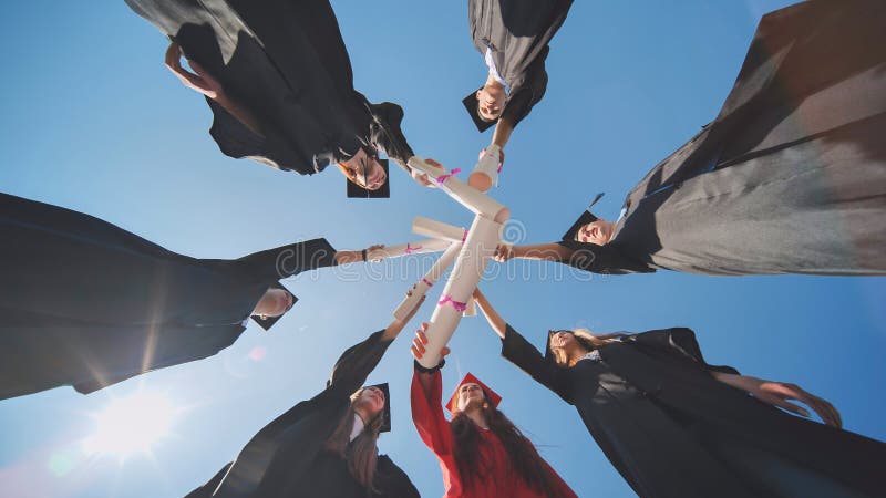 College Graduates Join Hands with Diplomas Standing in a Circle. Stock ...