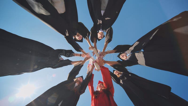 College Graduates Join Hands with Diplomas Standing in a Circle. Stock ...