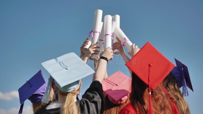 College Graduates with Multicolored Caps Tie Their Diplomas Together ...