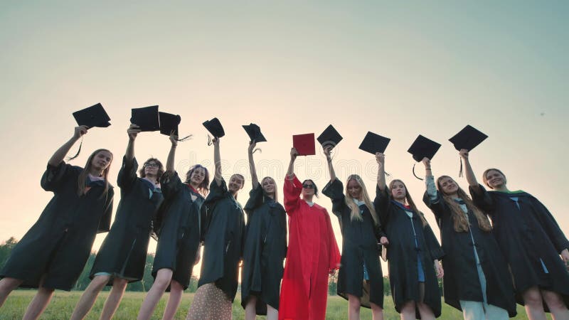 College Graduates Wave Their Caps on Graduation Night. Stock Video ...
