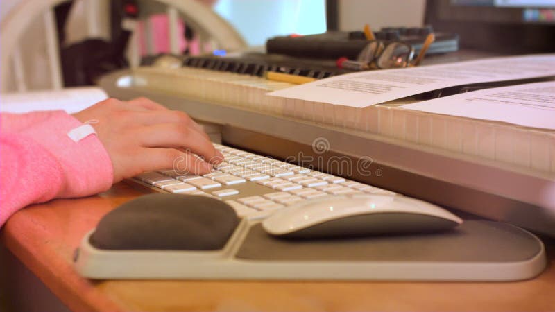 College High School Girl Types on Computer Keyboard Behind Stack of ...