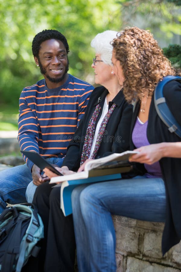 College Professor Helping Students Stock Photo - Image of happy ...