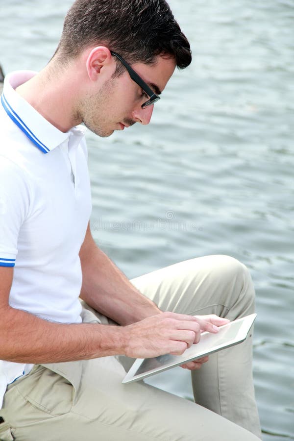 College Student Browsing Internet Using His Tablet Stock Photo - Image ...