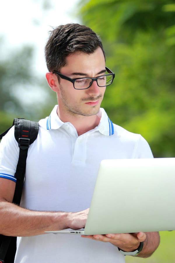 College Student Browsing Internet Using a Laptop Stock Image - Image of ...