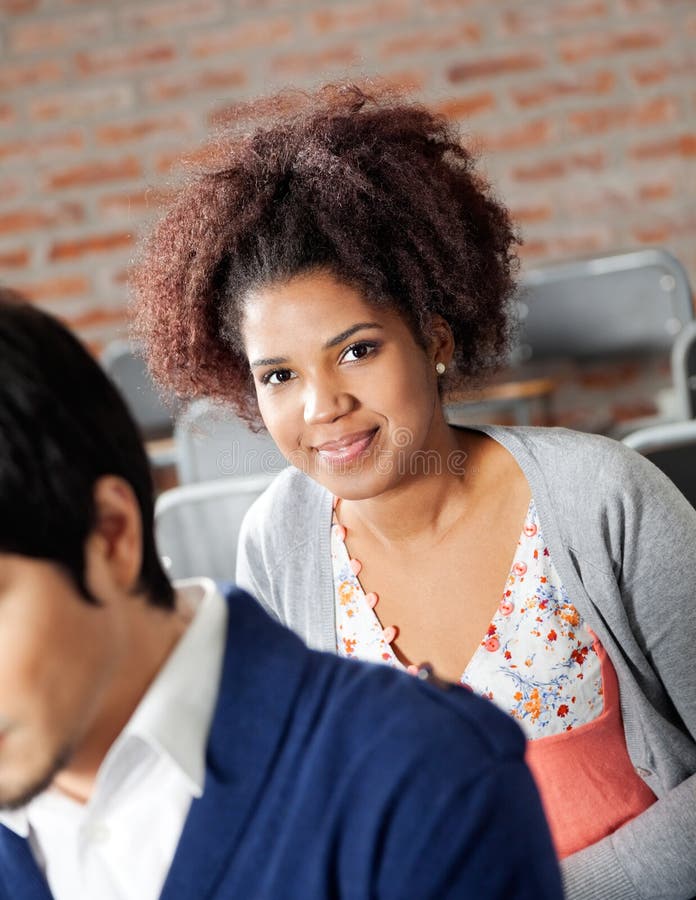 College Student with Classmate in Classroom Stock Photo - Image of ...